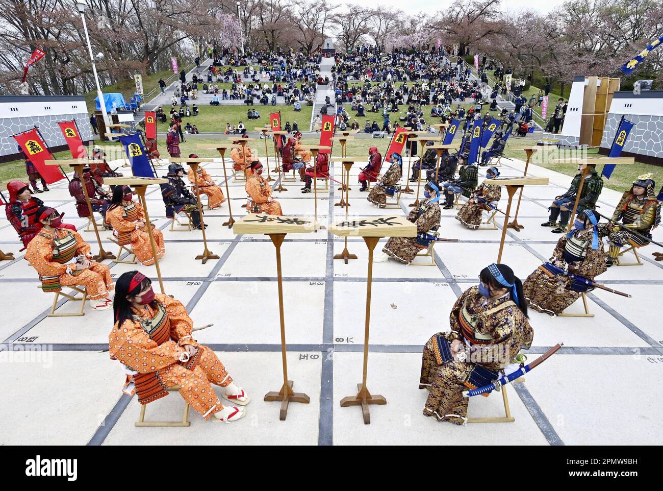 A shogi board game with "human pieces" is played on April 15, 2023, in ...