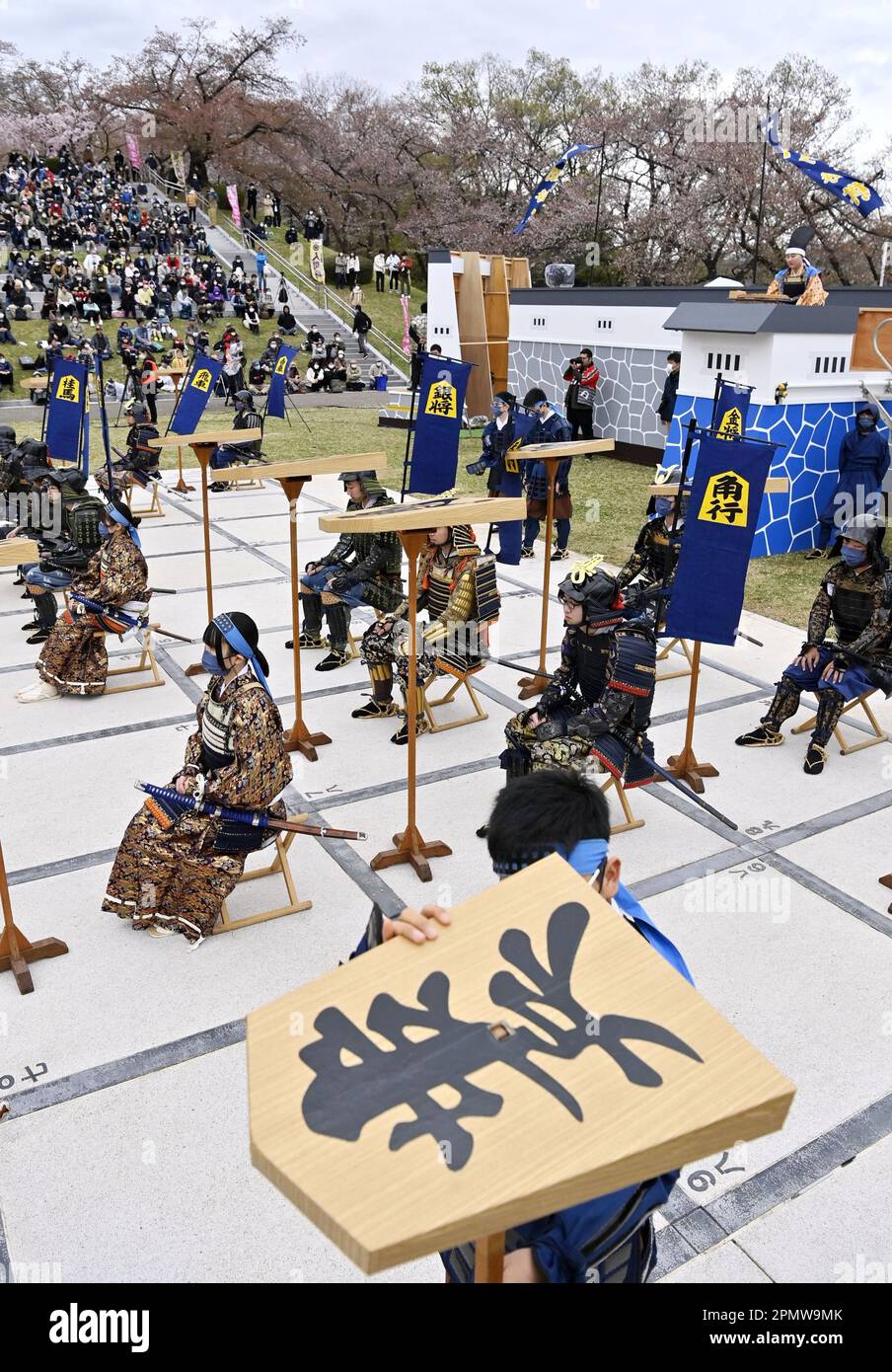 A shogi board game with "human pieces" is played on April 15, 2023, in ...