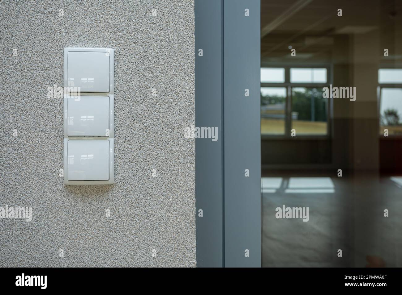 Electric switch on the wall inside the building located at the door ...