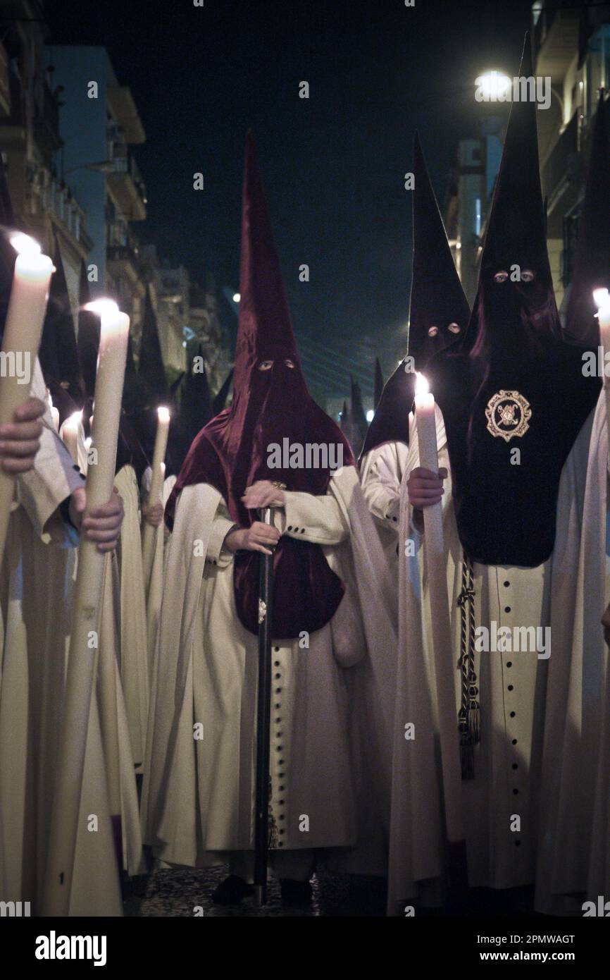 Penitents of the Virgen de la Macarena in the Holy Week procession ...