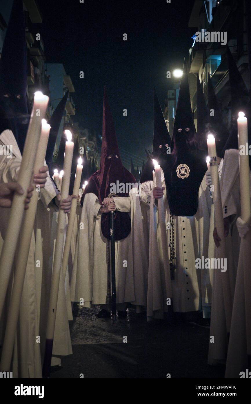 Penitents of the Virgen de la Macarena in the Holy Week procession ...