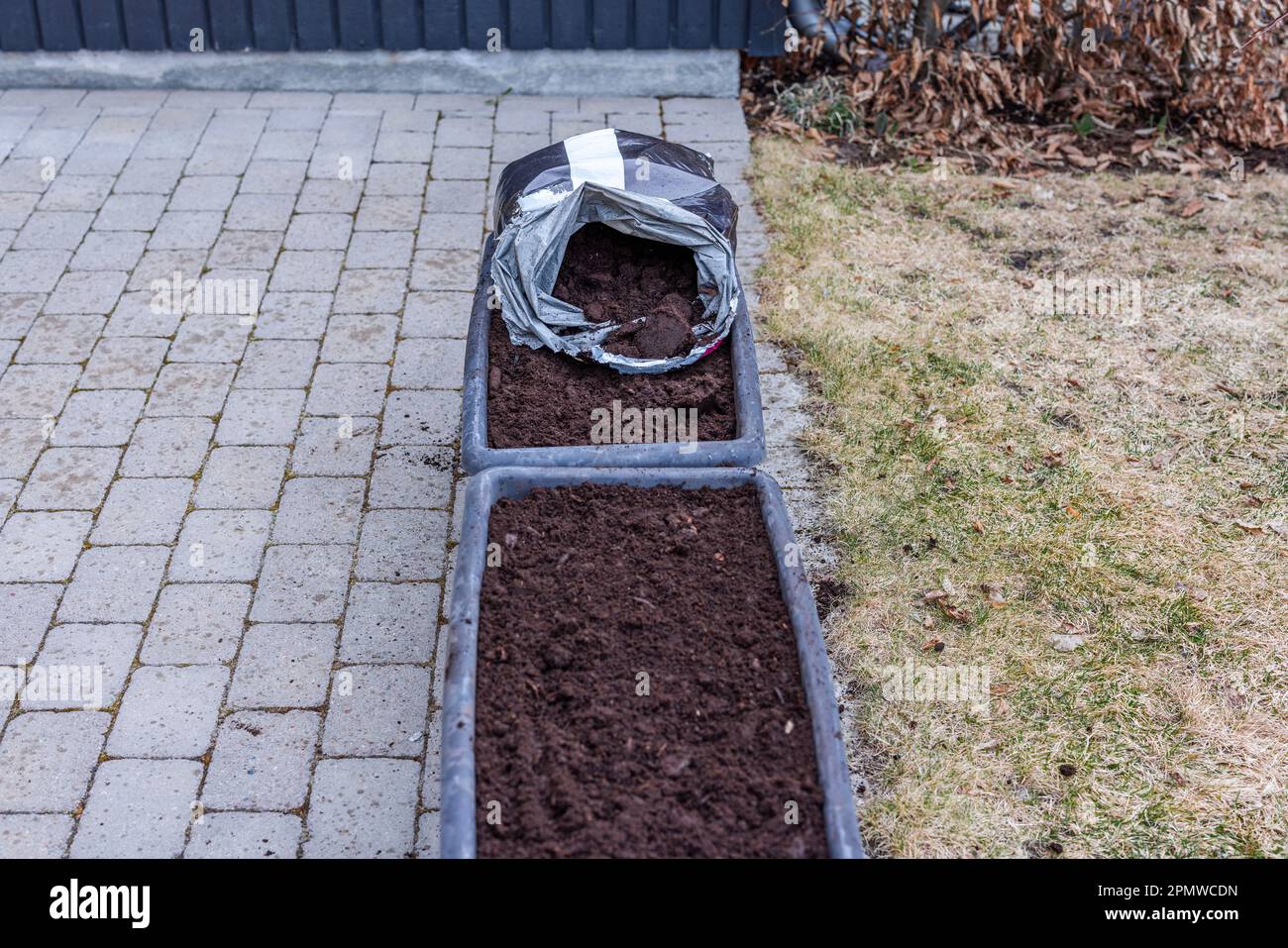 Close up view of bag of earth and boxes of soil prepared for planting ...
