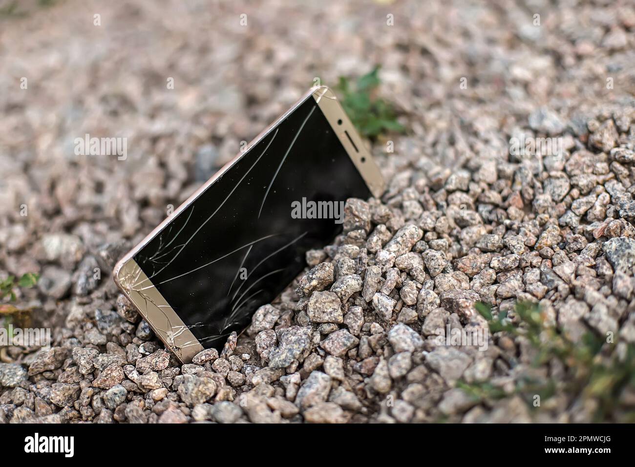 broken phone on stone paved sidewalk outdoors. Lost on walk smartphone ...