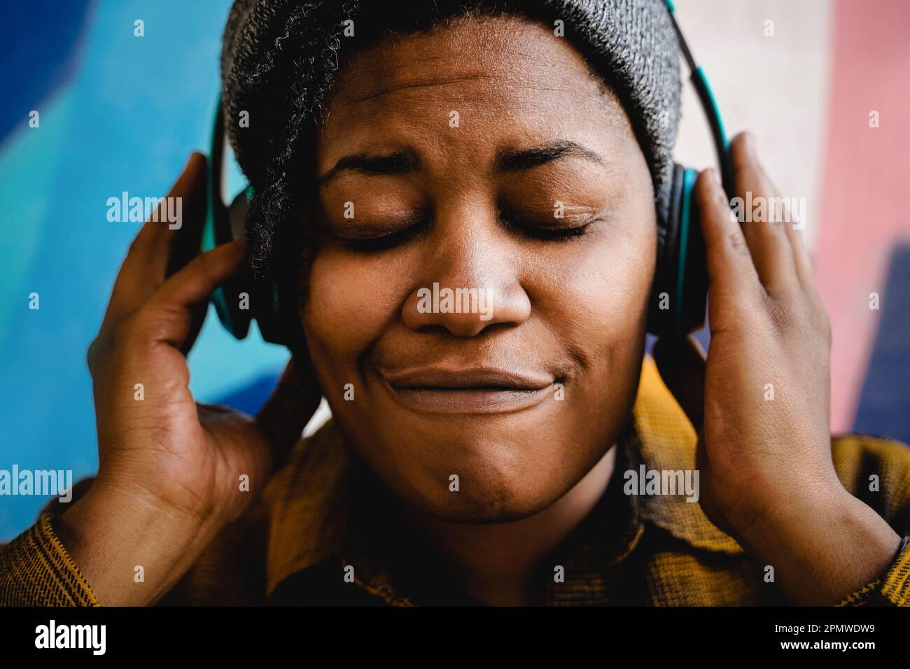 African woman listening music peaceful playlist with headphones ...
