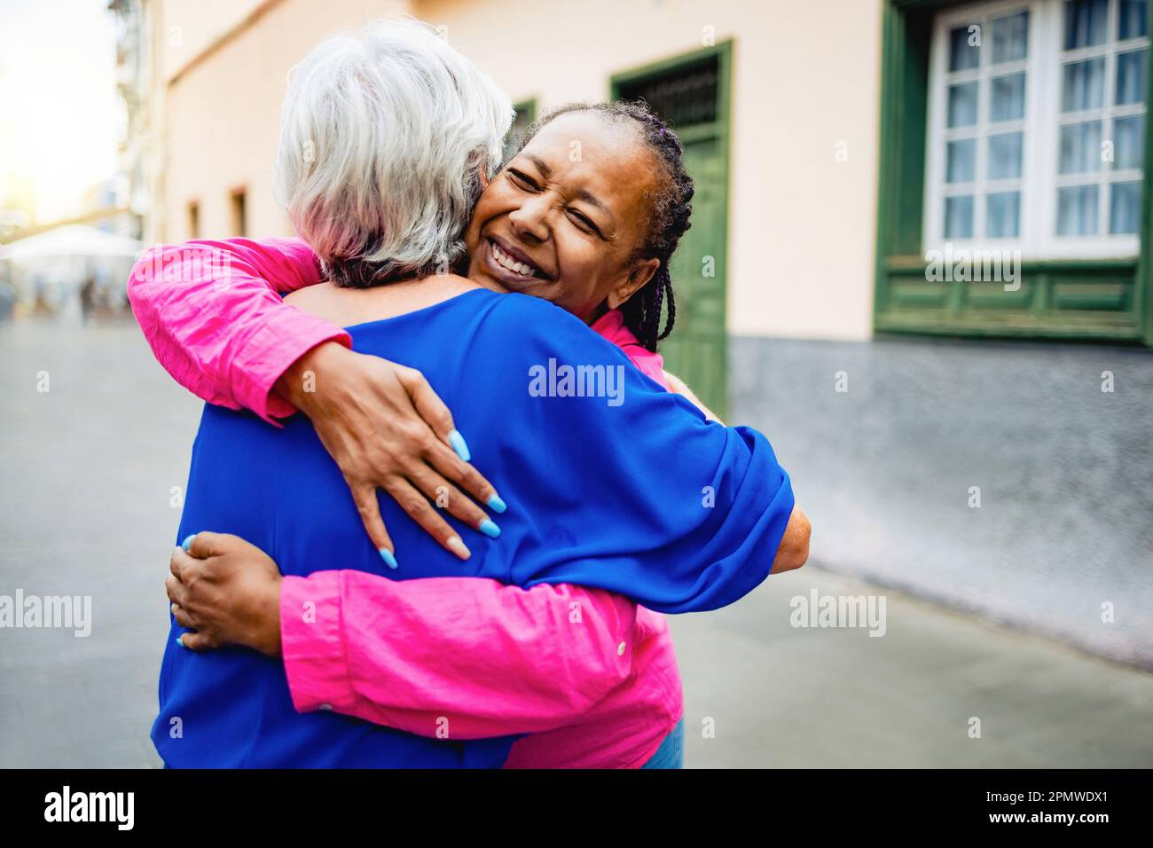 Multiracial senior women hugging each other - Elderly friendship and ...
