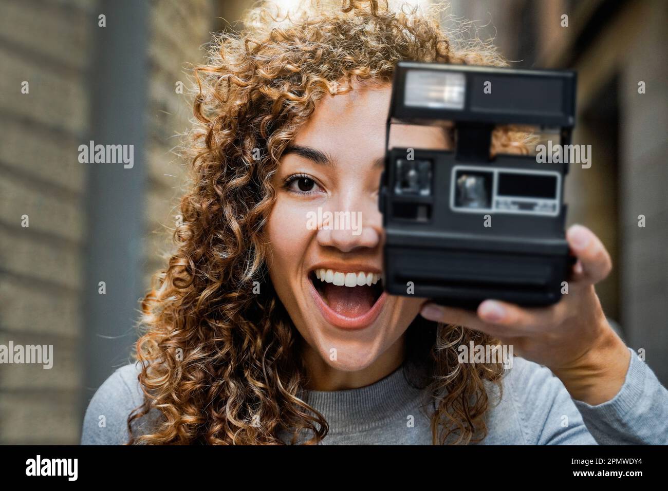 Young woman photographer taking instant pictures with old vintage ...