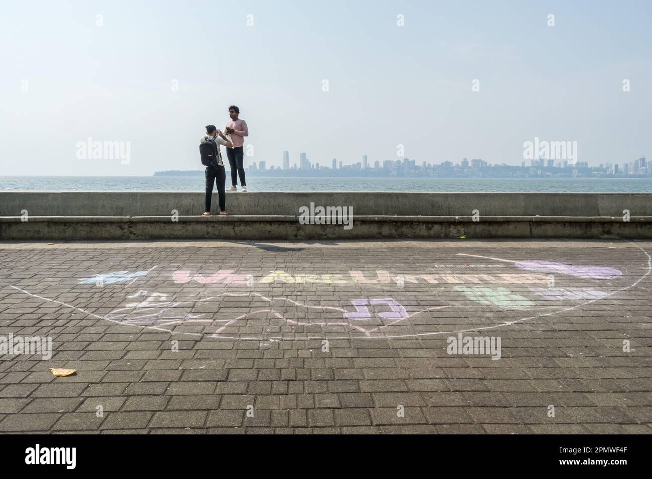 Two people with a beautiful urban landscape of the skyline of Mumbai ...