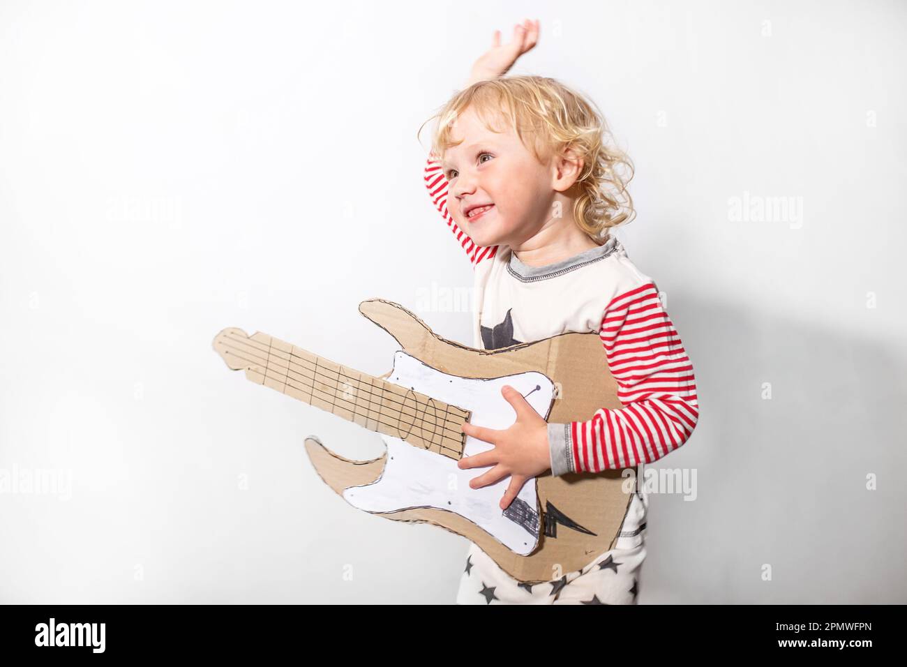 Child playing musical instrument funny hi-res stock photography and ...