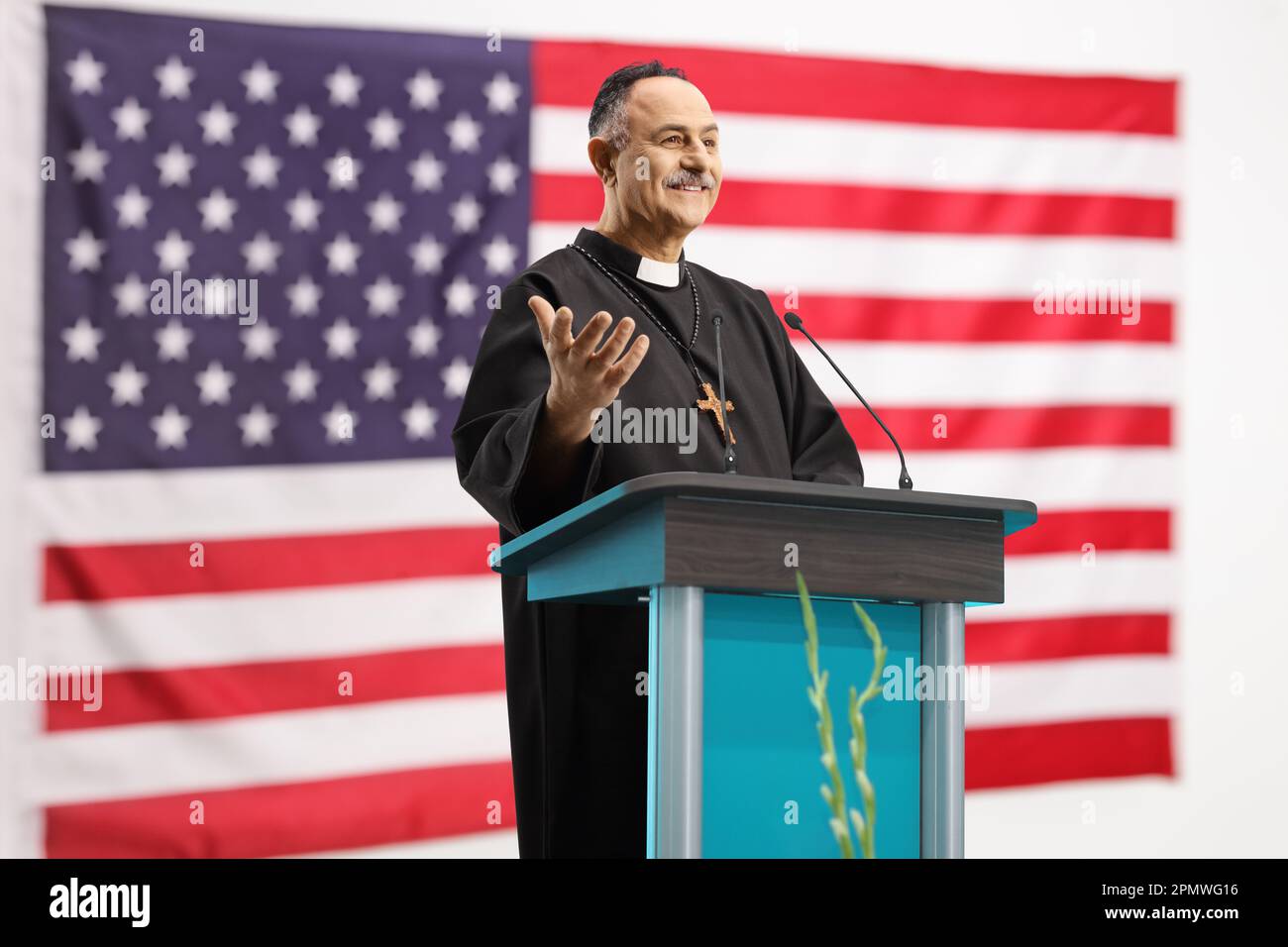Priest giving a speech on a podium in front of a USA flag Stock Photo ...