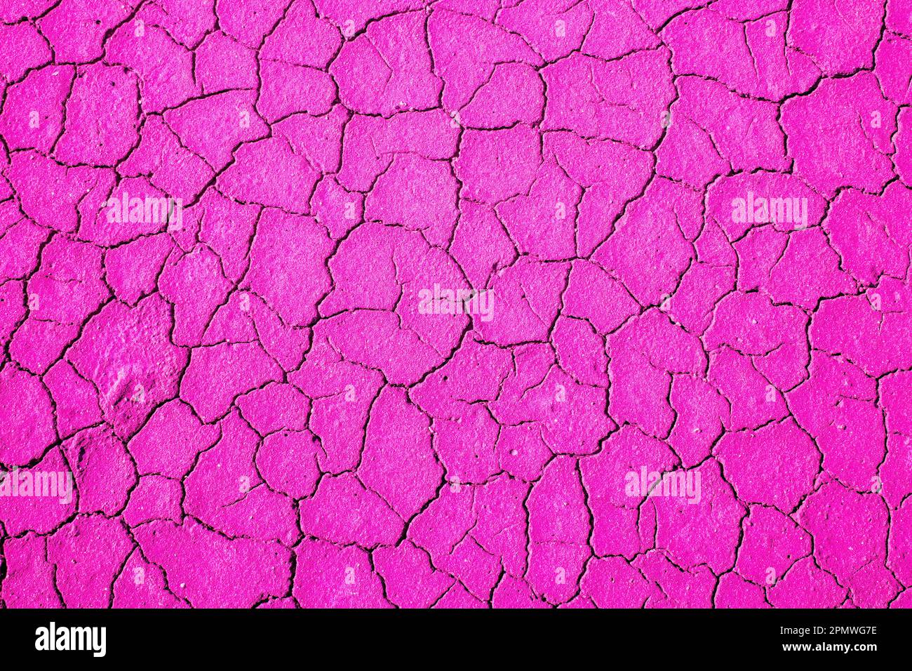 A vibrant pink ground surface with cracks Stock Photo - Alamy
