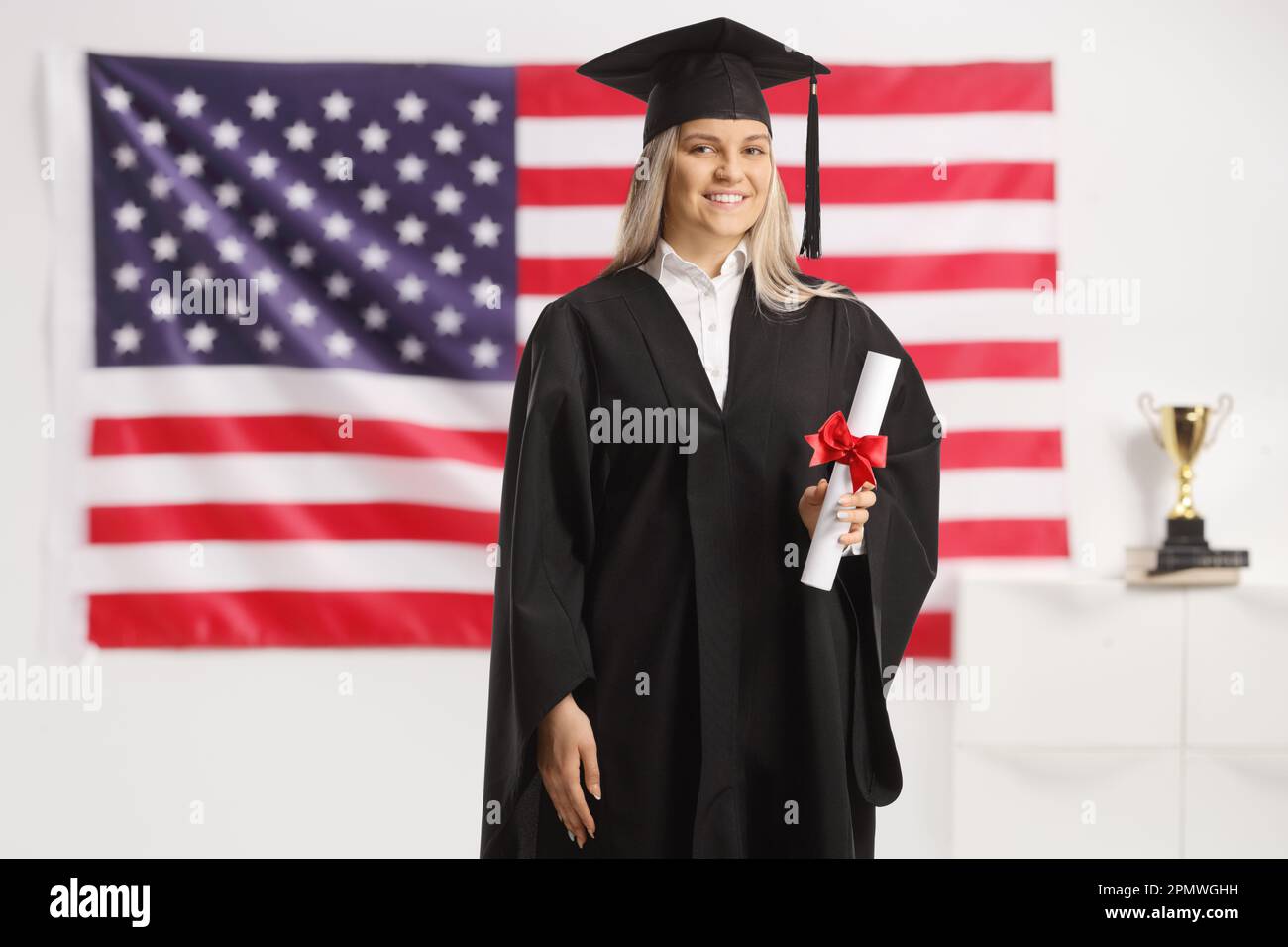 Female graduate student holding a bachelor degree certificate in front ...