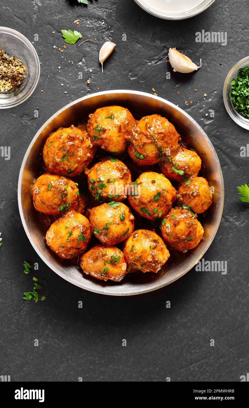 Pan fried little baby potatoes with jeera seeds and coriander in bowl ...