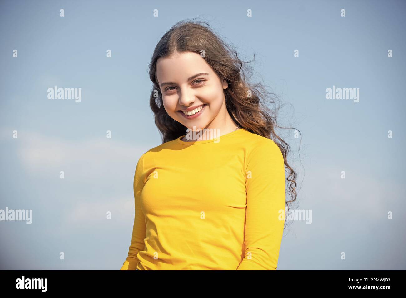 teen girl with positive face on sky background Stock Photo - Alamy