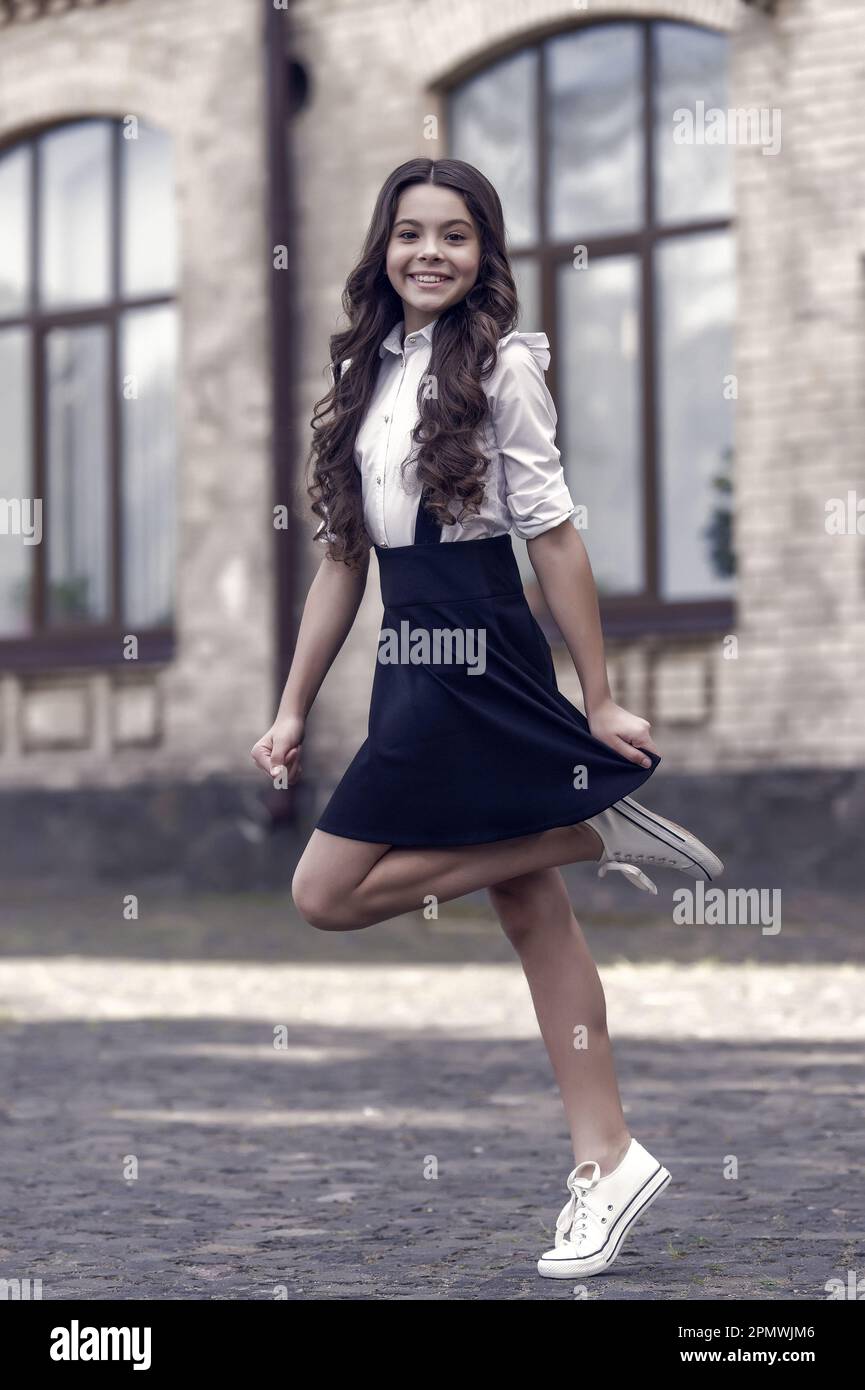 Energetic cute kid hurry to class wearing formal uniform on September 1 ...