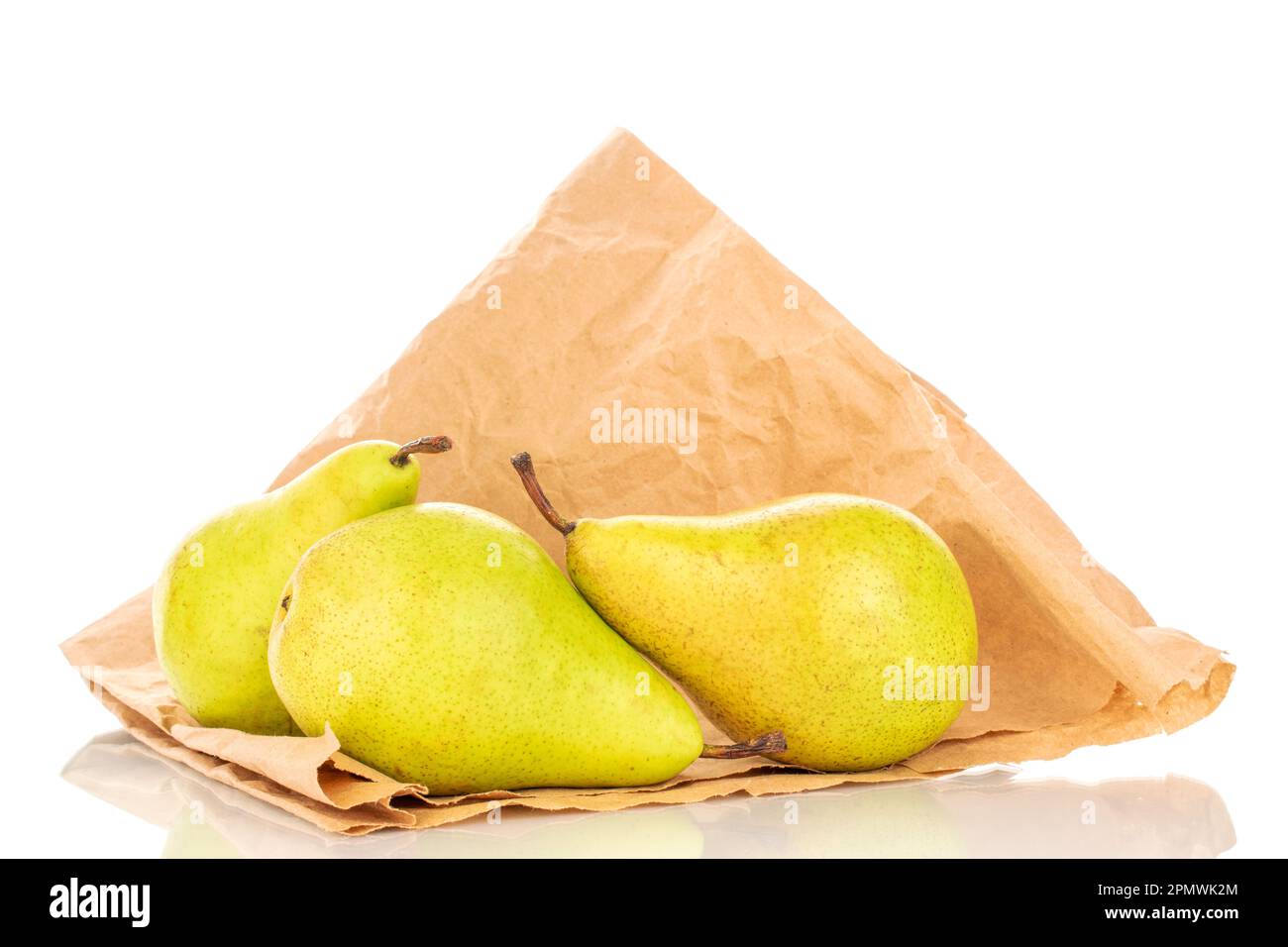 Three sweet pears on a paper bag, macro, isolated on white background ...