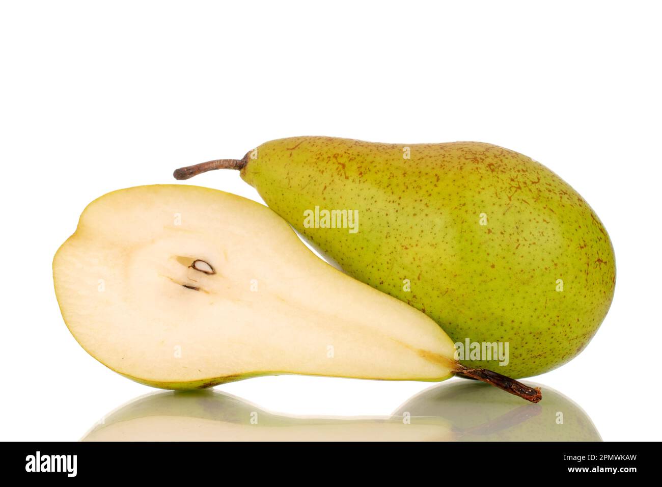 One whole and one half ripe organic pear, macro, on white background ...