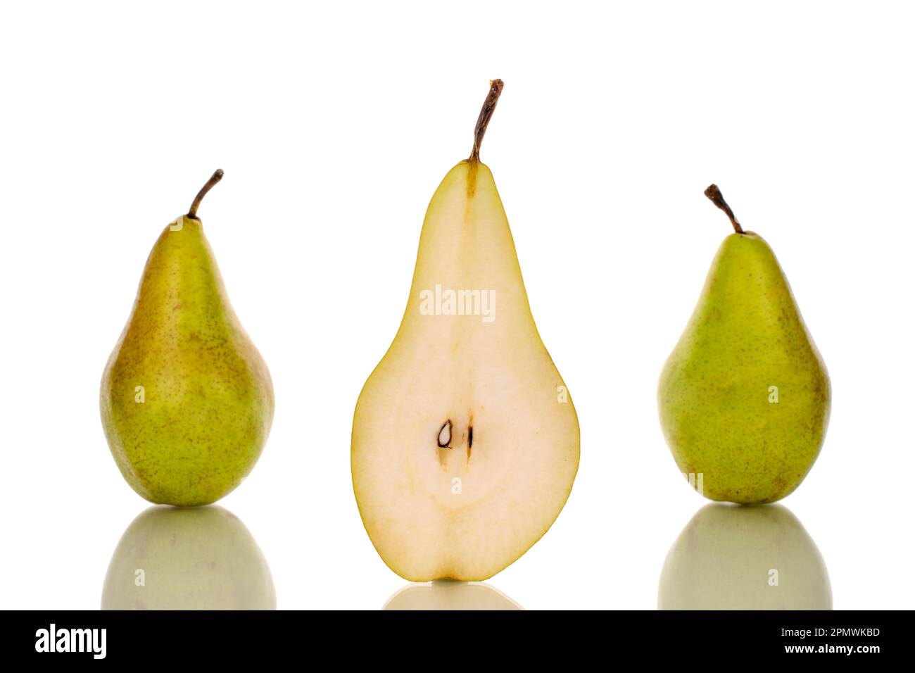 Two whole and one half ripe organic pears, macro, on a white background ...