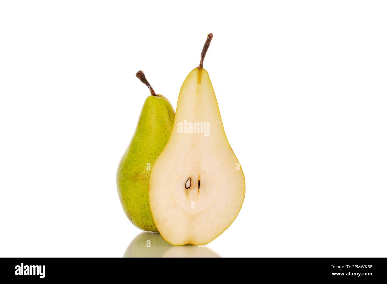 One whole and one half ripe organic pear, macro, on white background ...