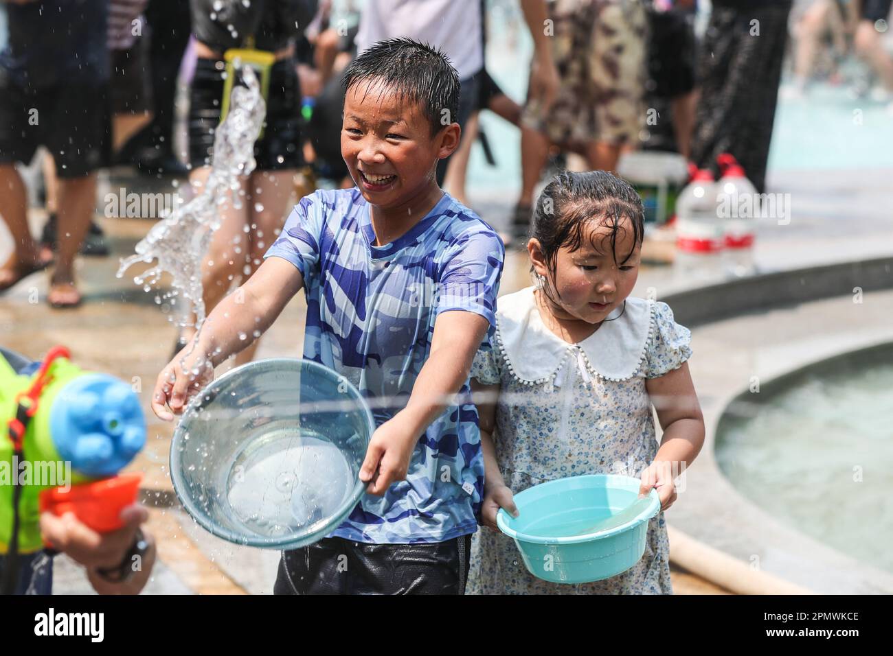 Jinghong, China's Yunnan Province. 15th Apr, 2023. People splash water ...
