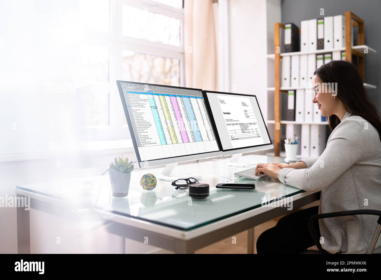 Using Corporate Invoice Spreadsheet On Computer Monitors Stock Photo ...