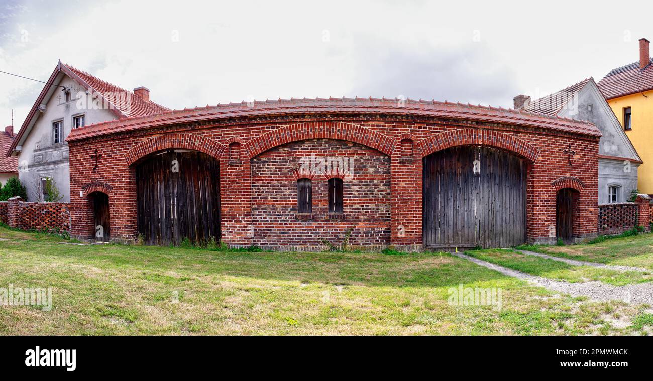 A traditional brick Silesian farm entrance gate in a village Stock ...