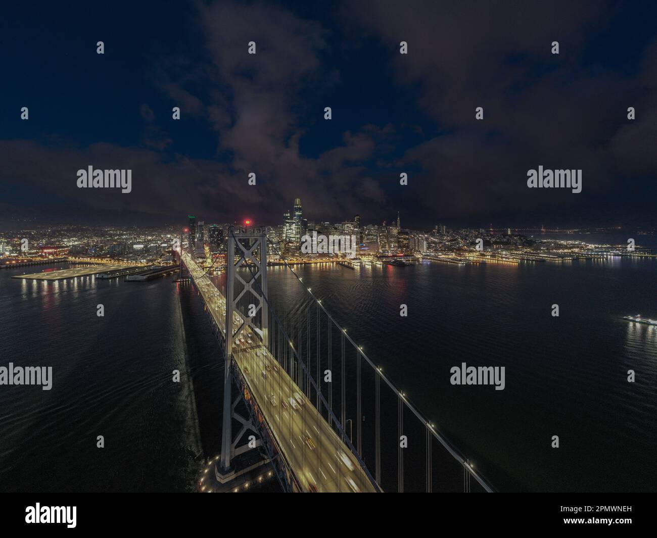 An aerial view of the iconic Bay Bridge at night, captured from an ...