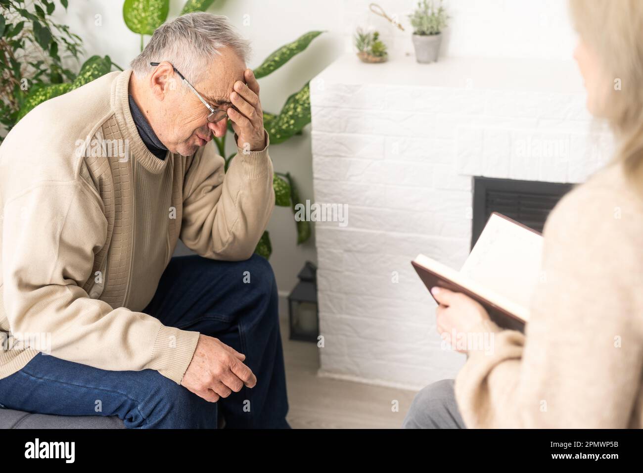 Senior man patient and young woman caregiver medical worker in uniform ...
