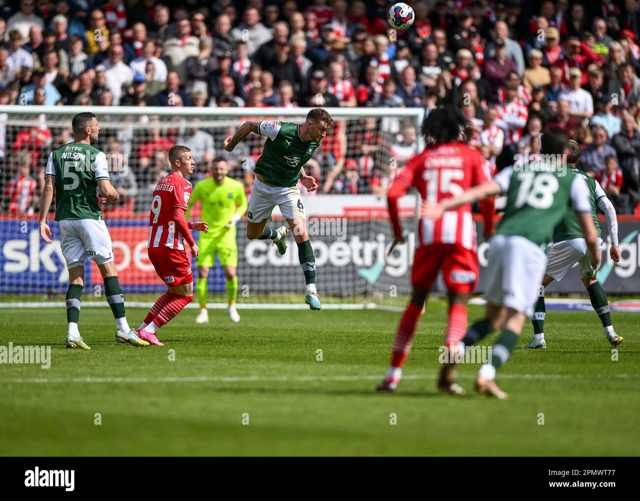Dan Scarr #6 of Plymouth Argyle heads the ball away to safety during ...