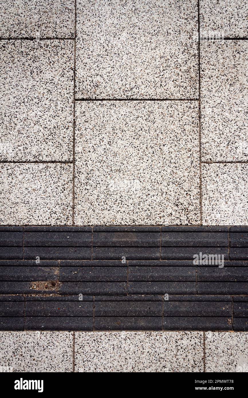 Textured walkway for blind people. Black tactile paving for the ...