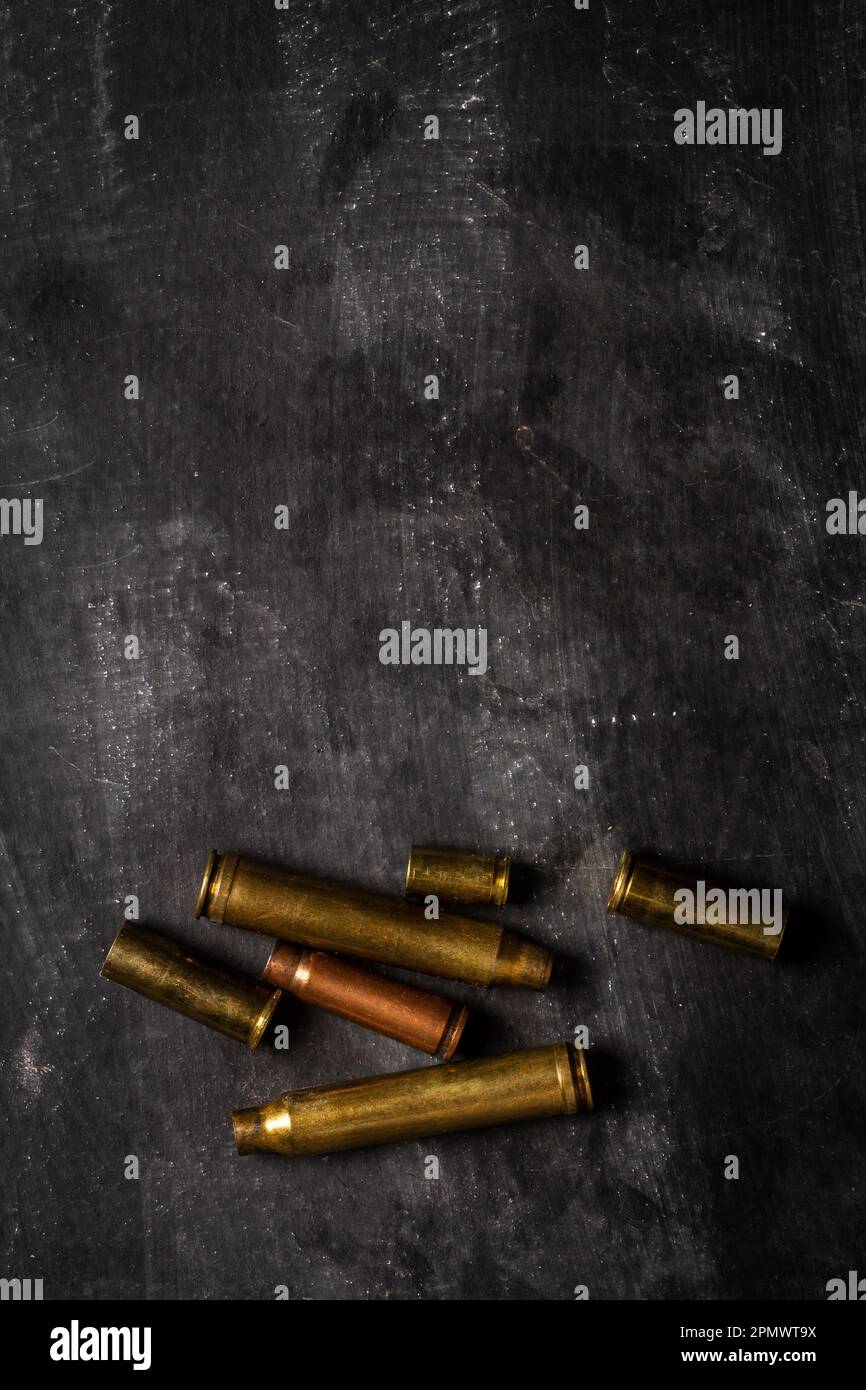 Empty bullet cartridges lying on the black background Stock Photo - Alamy