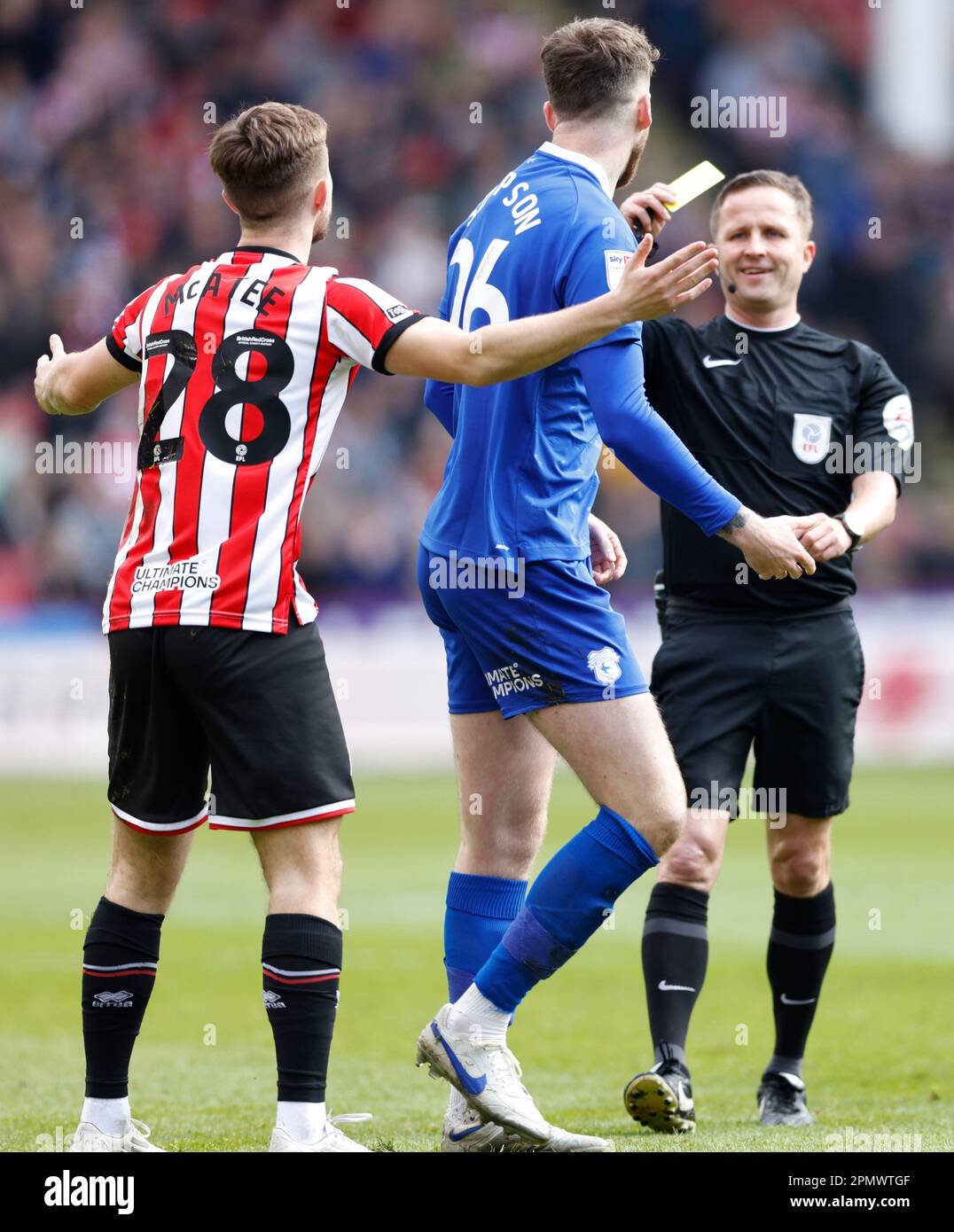 Cardiff City's Jack Simpson (centre) gets shown a yellow card by the ...