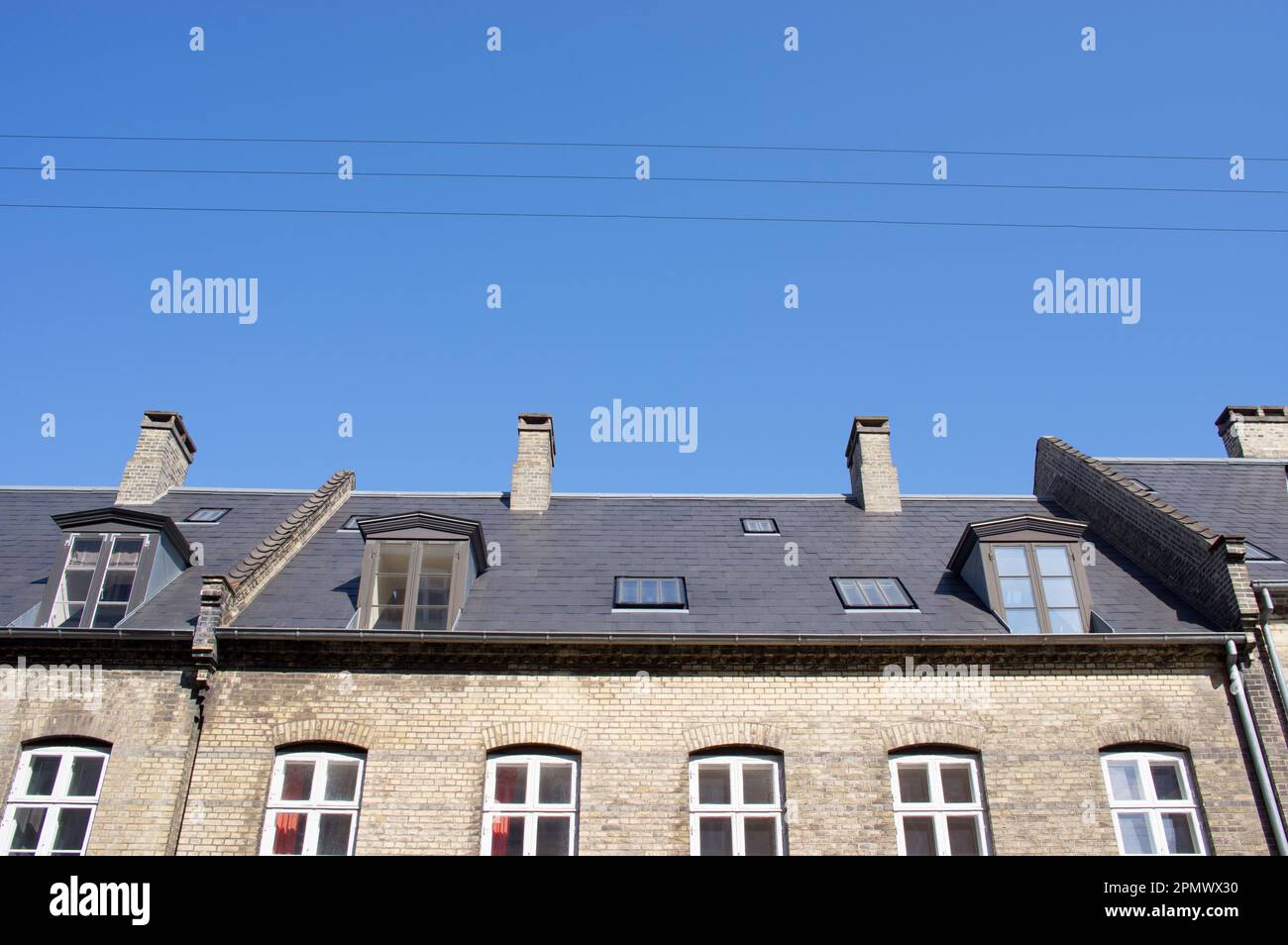 Facade and roof of a historic terraced house with dormer swith a clear ...