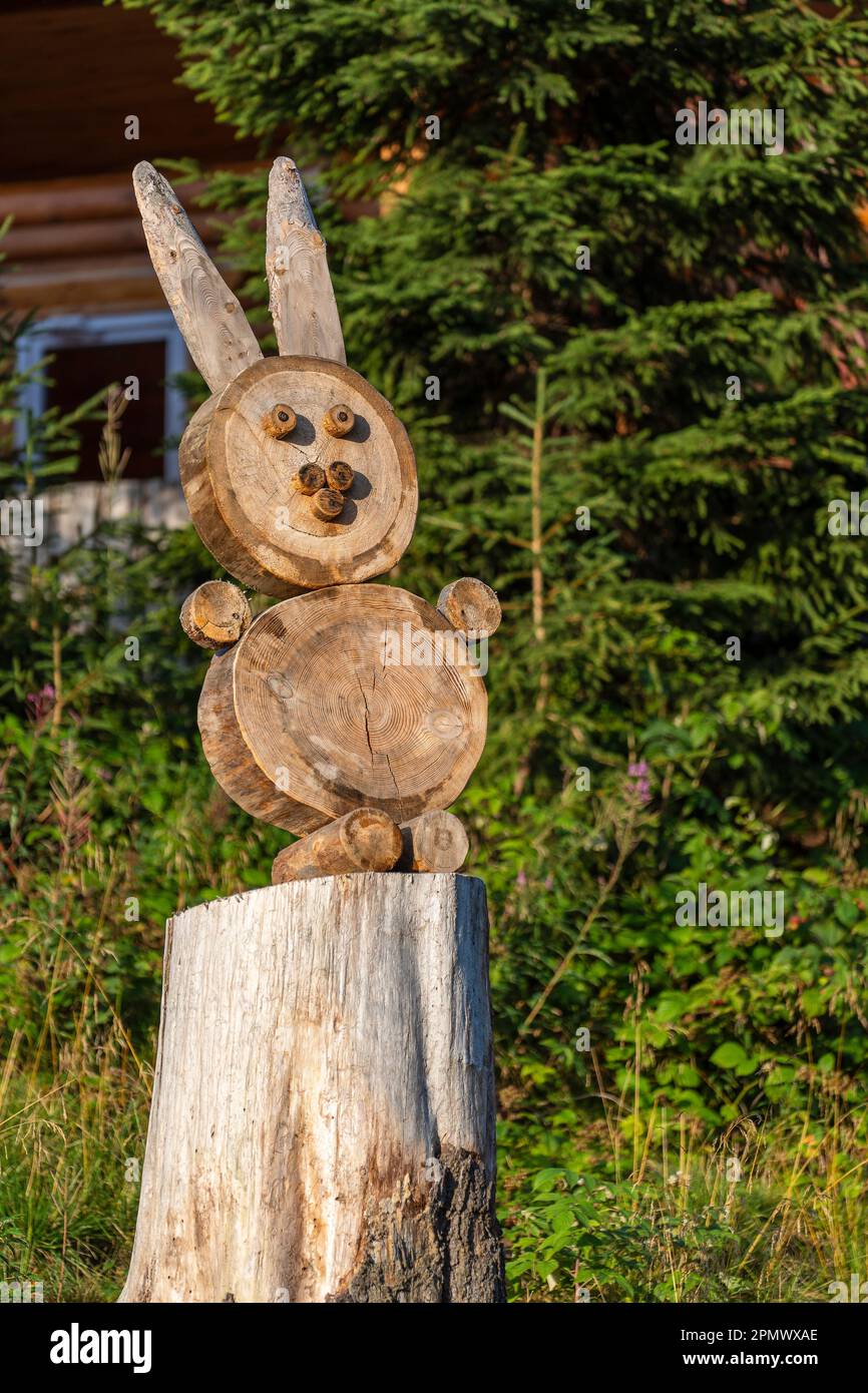 Wooden hare from a felled tree on a stump along the road in the ...