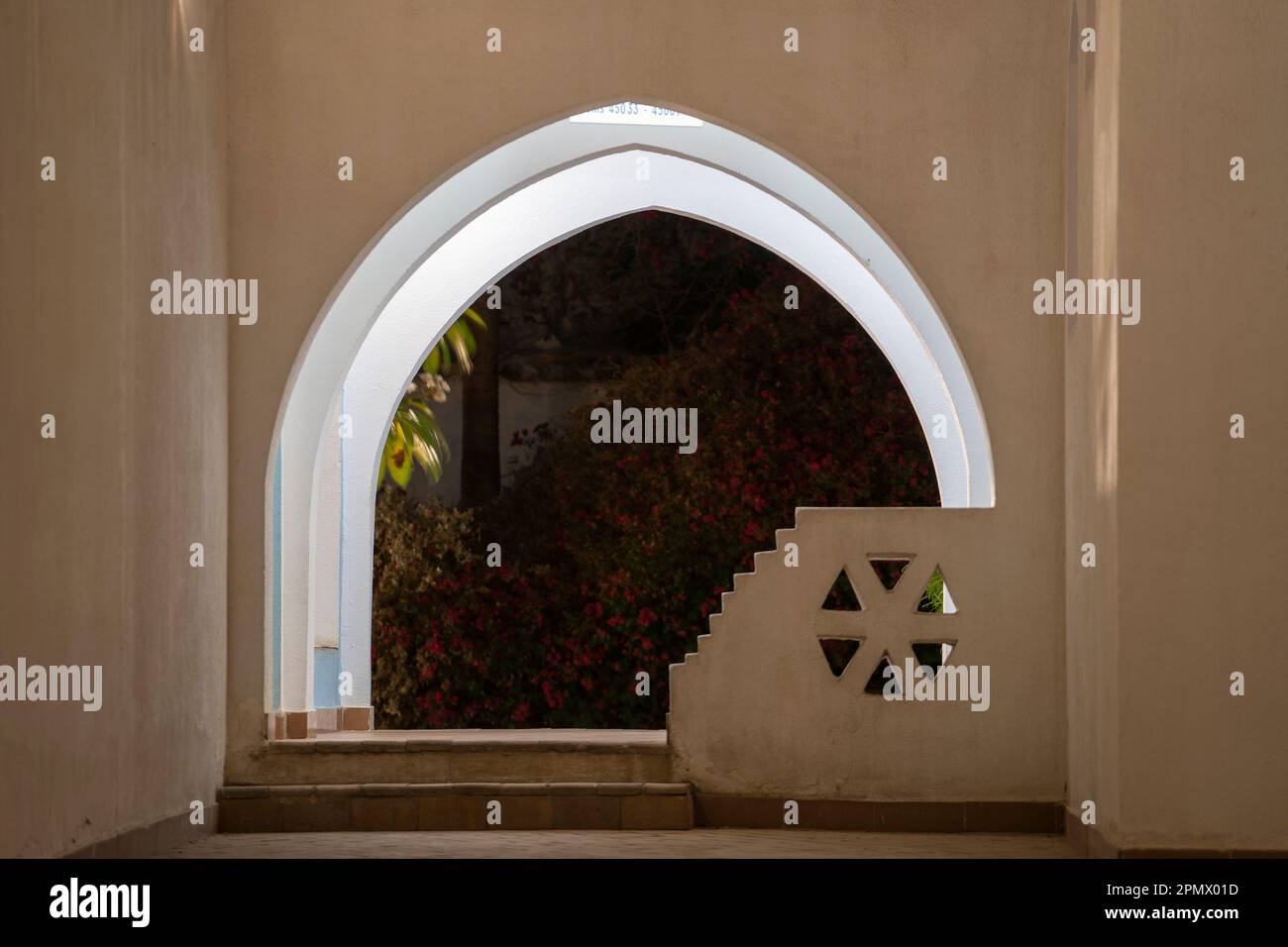 Archway on a white wall at night on the street of Egypt in Sharm El ...