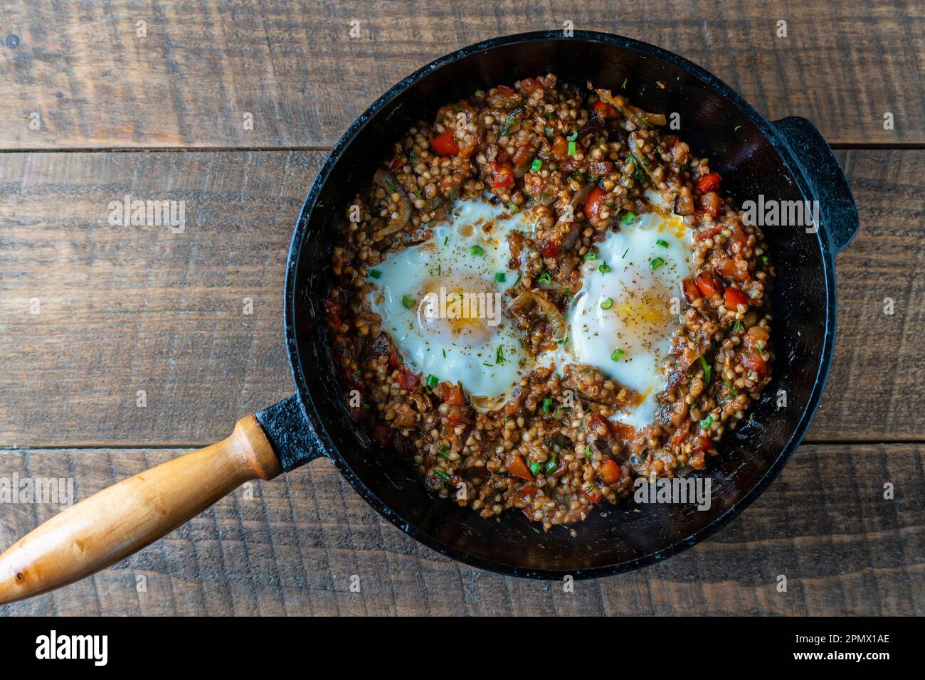 Boiled buckwheat with fried eggs, red peppers, carrots and onions ...