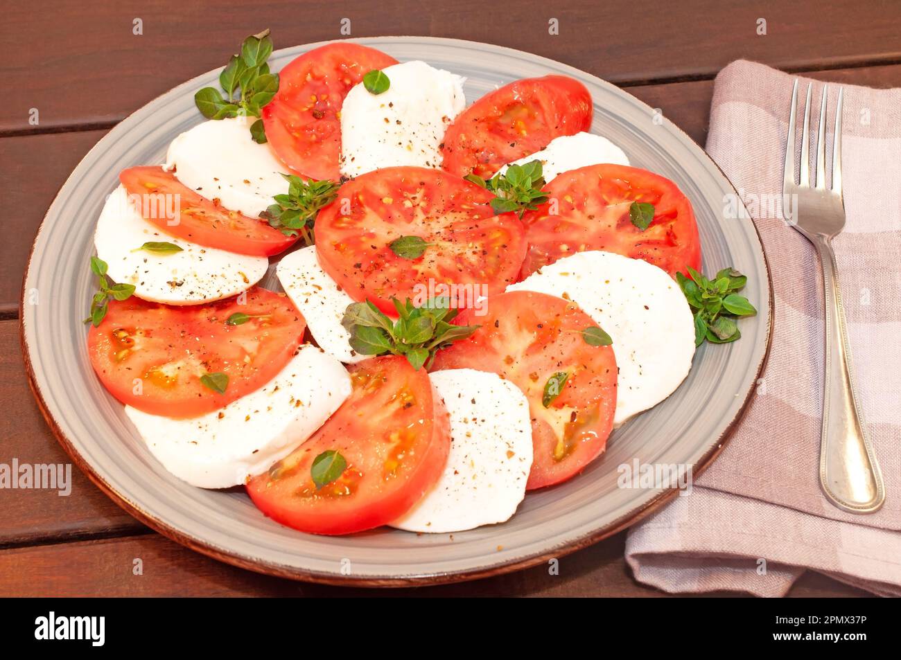 Tomato and mozzarella Caprese salad with sauce Stock Photo - Alamy