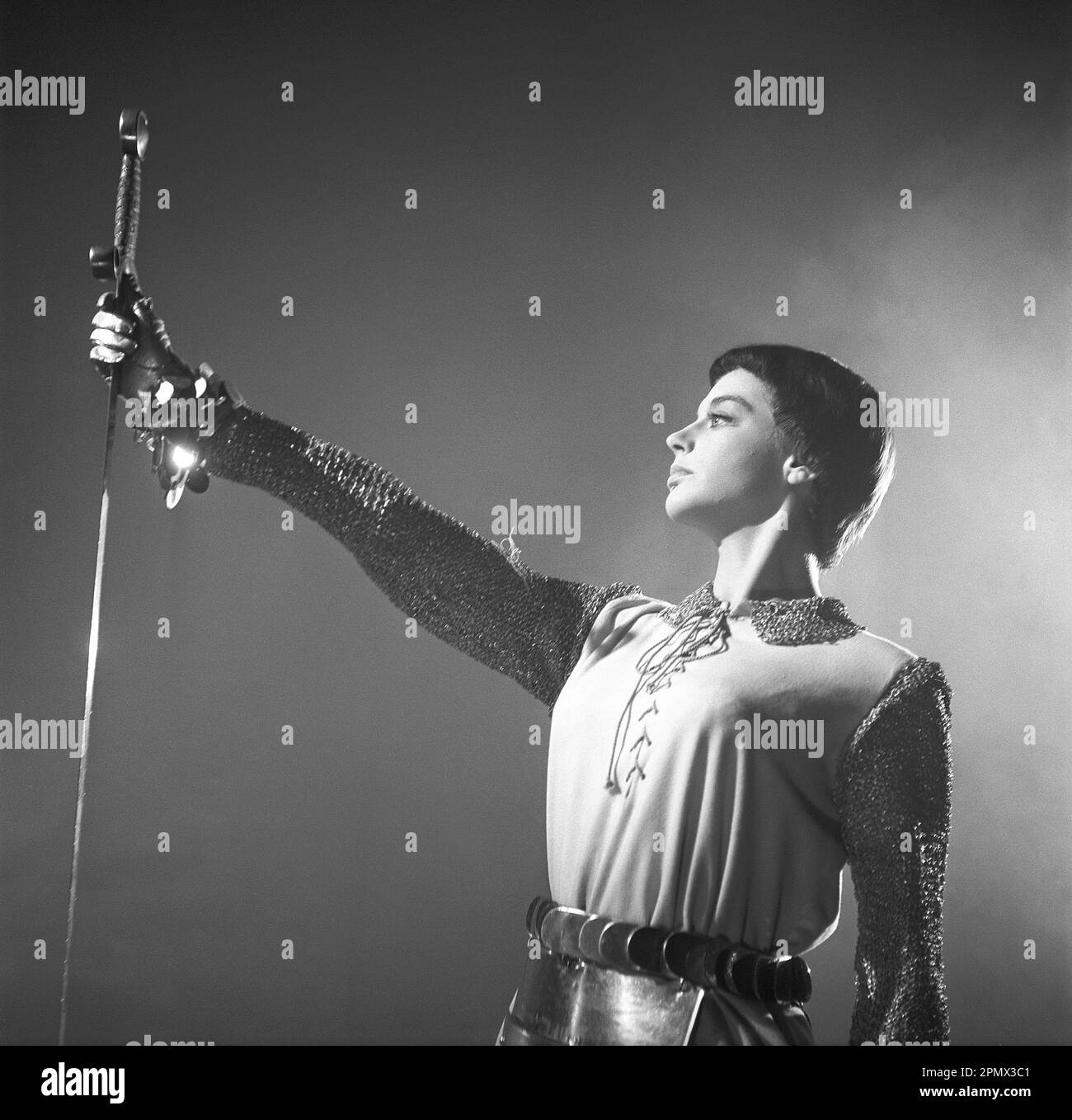 Female knight. A young woman dressed as a knight with armour is holding ...