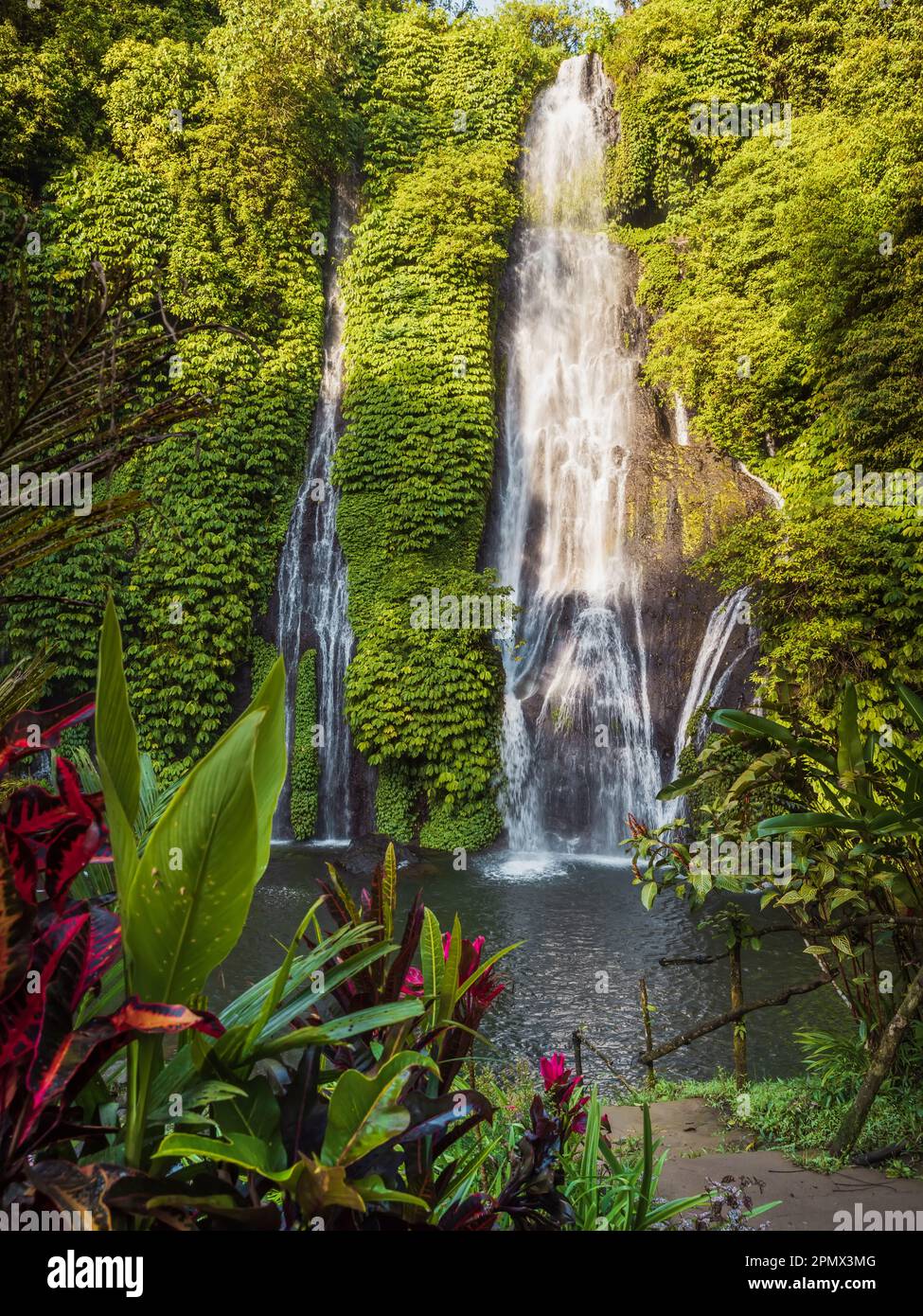 Scenic waterfall with crystal blue water and rainbow in tropics. Jungle cascade waterfall in ...