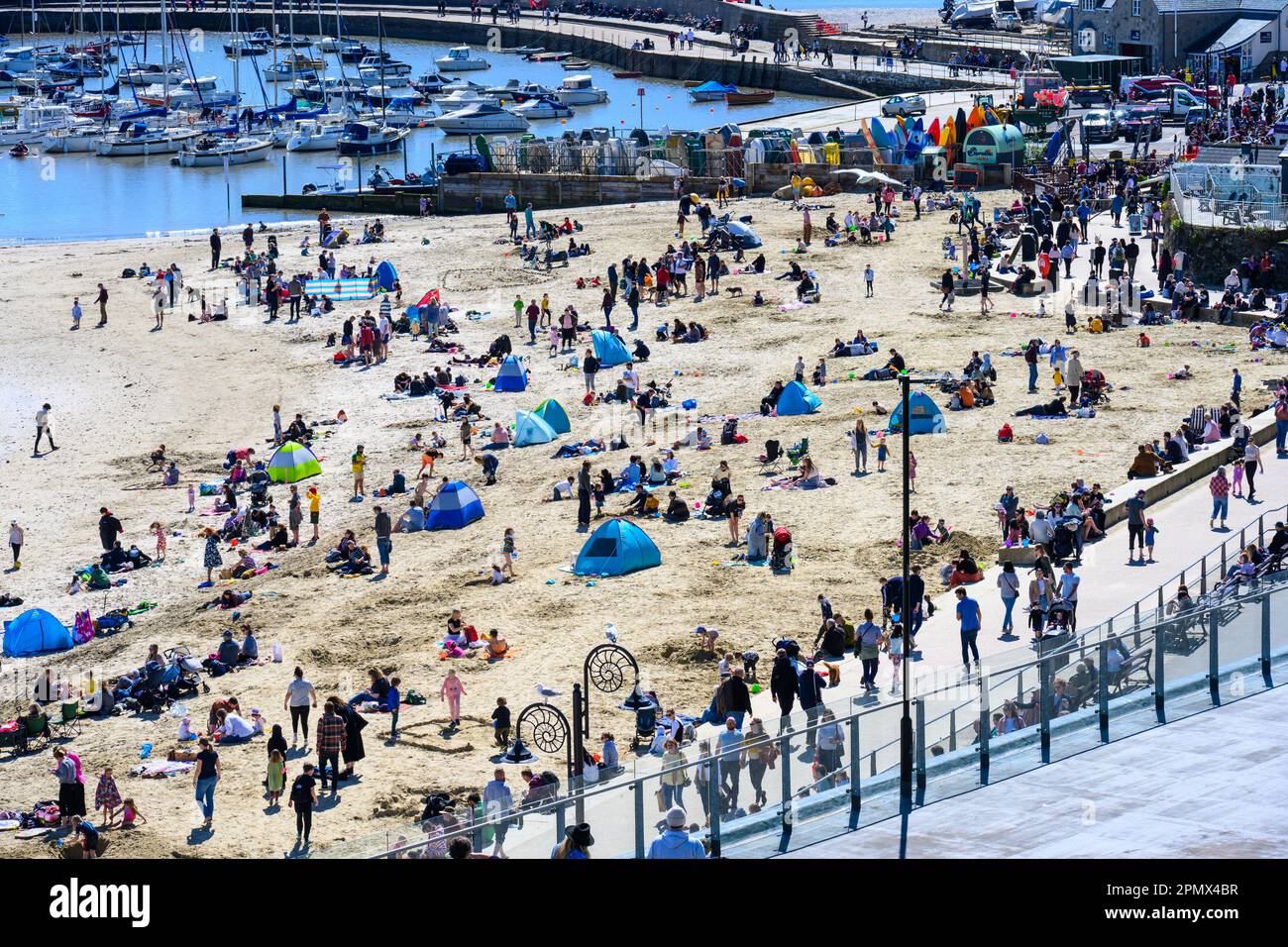 Lyme Regis, Dorset, UK. 15th Apr, 2023. UK Weather: Beachgoers and ...