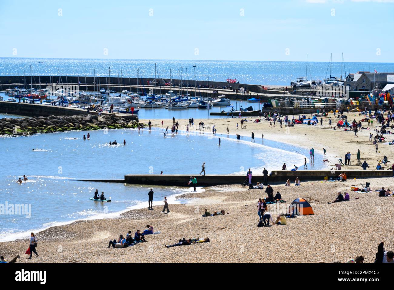 Lyme Regis, Dorset, UK. 15th Apr, 2023. UK Weather: Beachgoers and ...