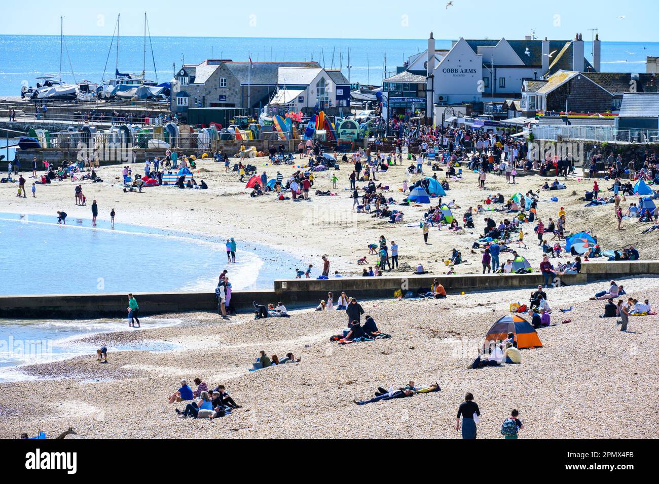 Lyme Regis, Dorset, UK. 15th Apr, 2023. UK Weather: Beachgoers and ...