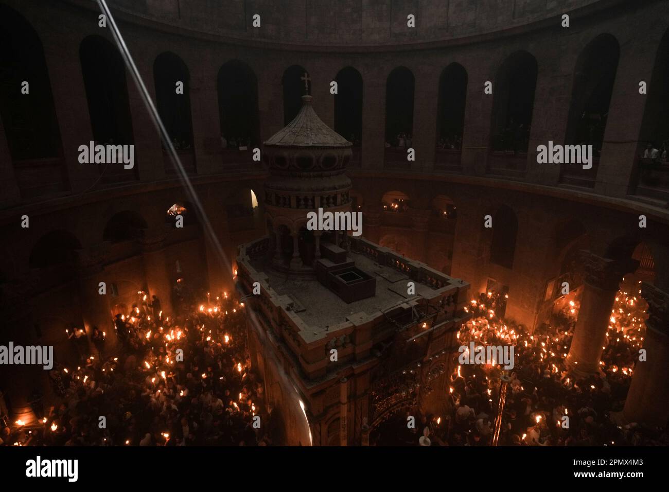 Christian pilgrims hold candles during the Holy Fire ceremony, a day ...
