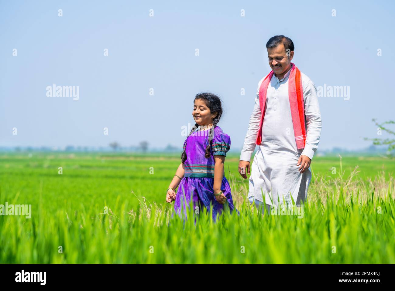 Happy indian playful kid with villager farming father at farmland ...