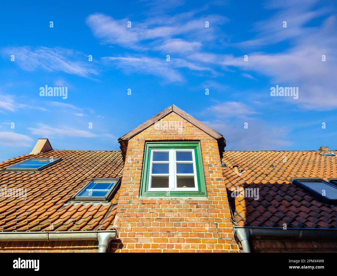 Open roof window in velux style with black roof tiles Stock Photo - Alamy