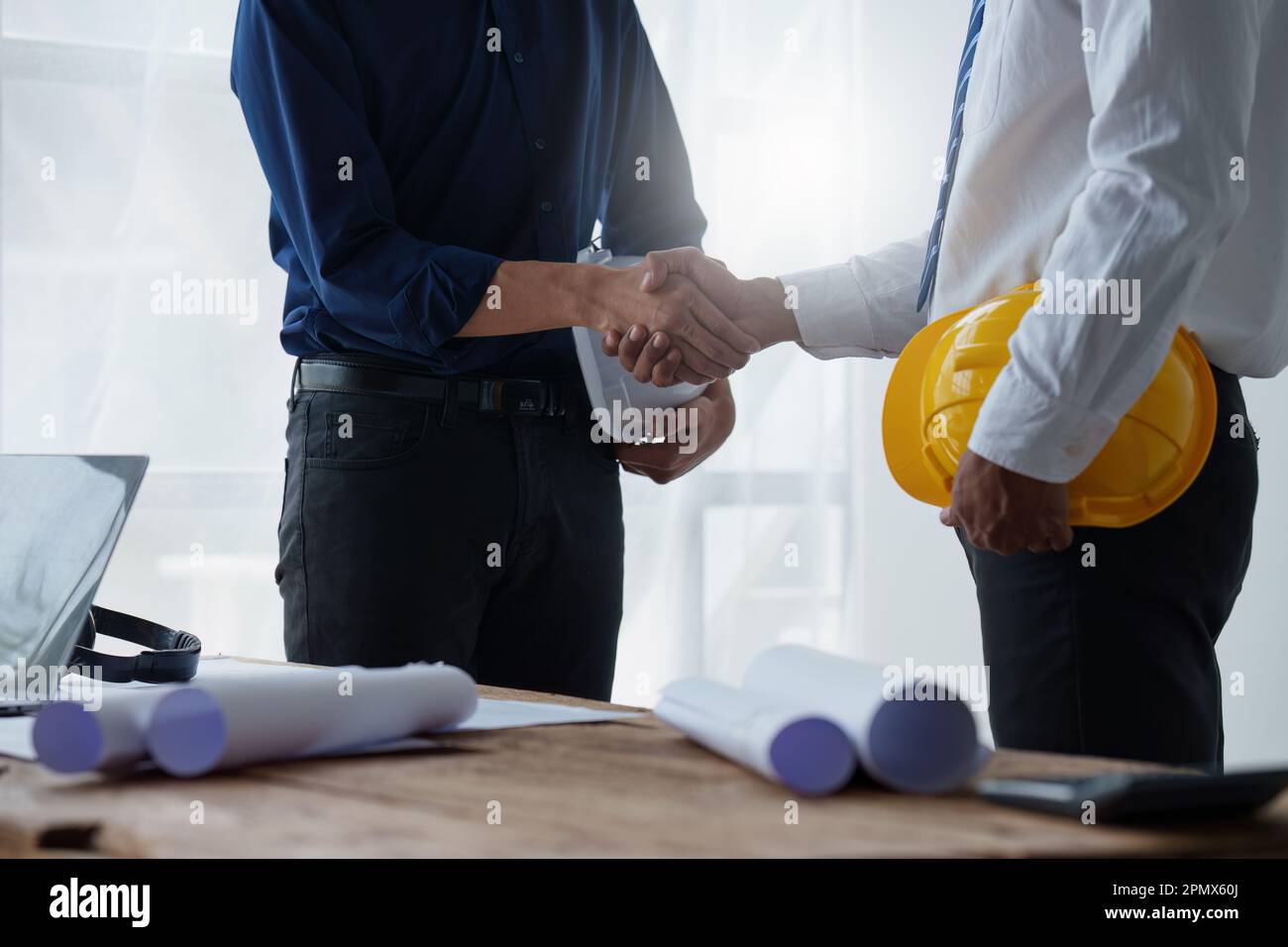 Architect and Engineer working with blueprints for architectural plan ...