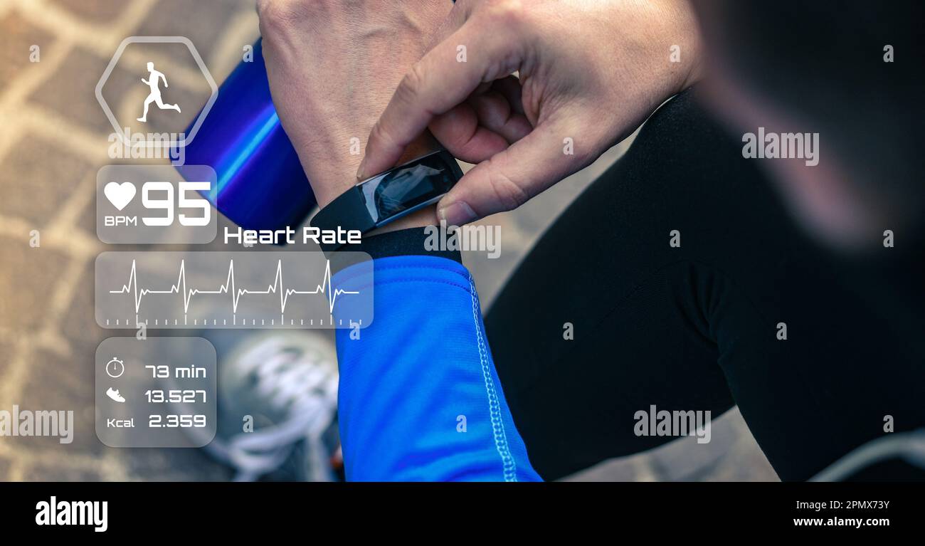 Man running in the park. Runner check heartbeat, steps and distance ...