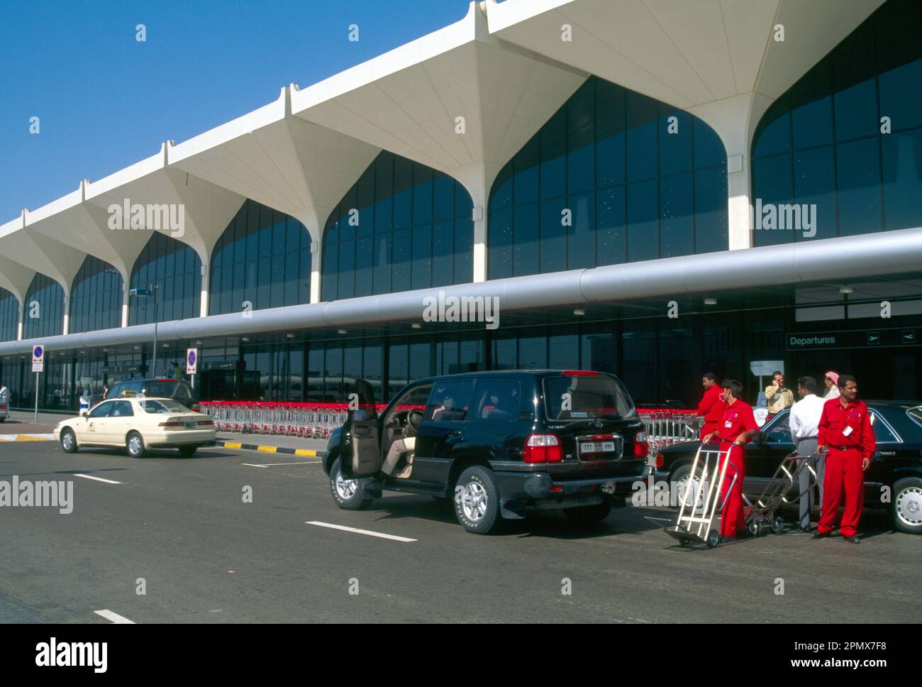 Dubai UAE Outside Dubai Airport workers with Sack Barrows to help move ...