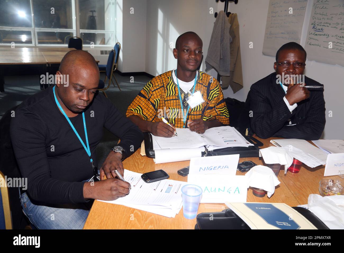 Nigerian Businessmen at Business Conference doing Paperwork England ...