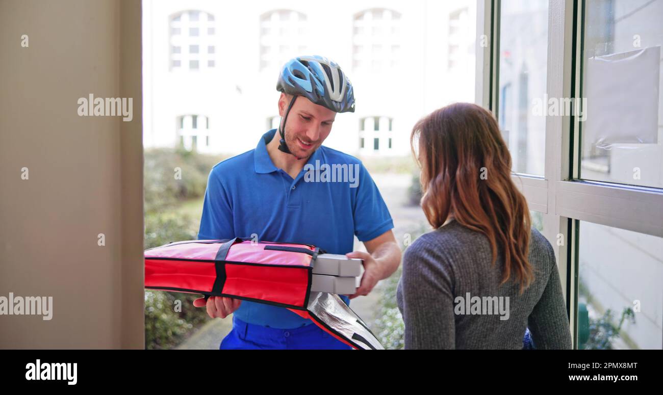 Pizza Delivery Man Giving Pizza Boxes To Smiling Young Woman Stock ...