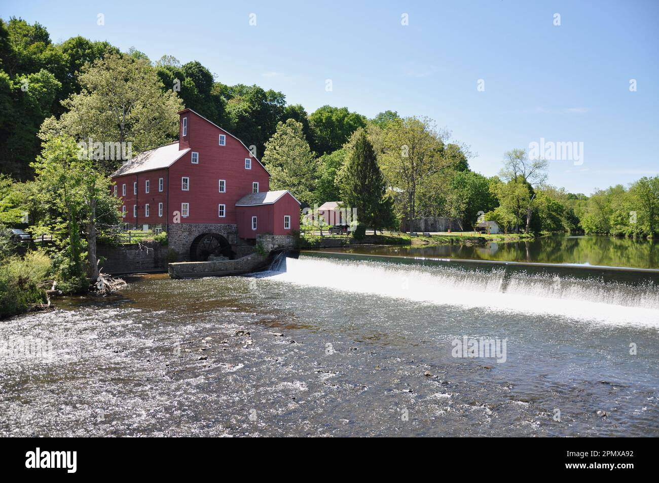 A red mill in the forest alongside a wide river in Hunterdon, New ...
